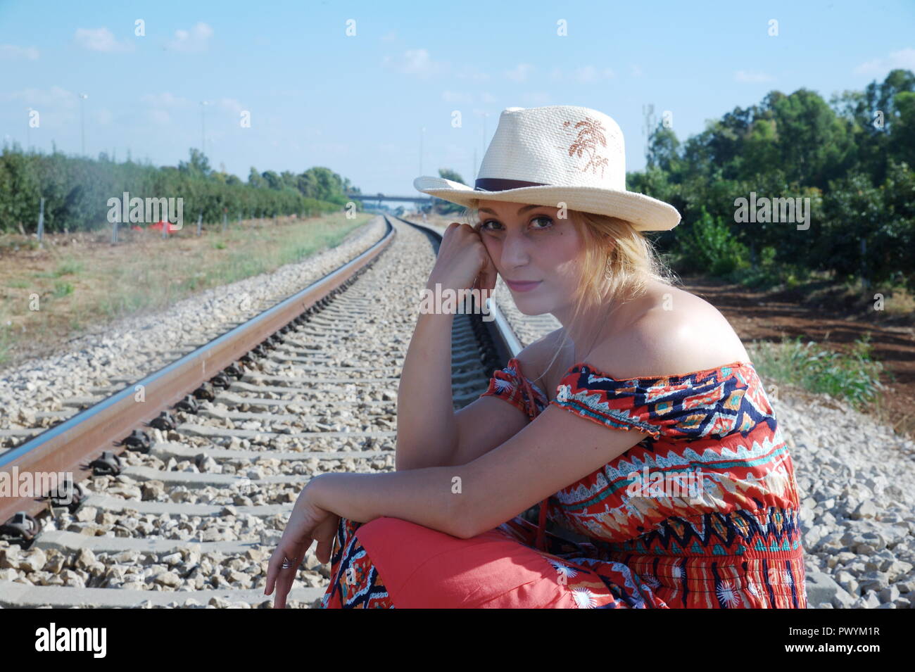 an amazing young blonde lady wait to locomotive, try stop train Stock ...
