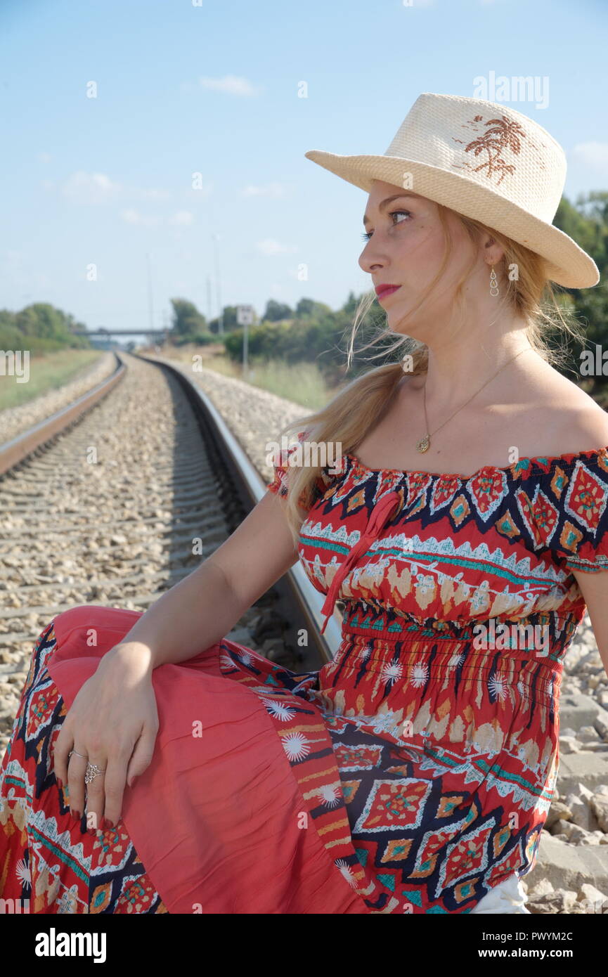 an amazing young blonde lady wait to locomotive, try stop train Stock ...