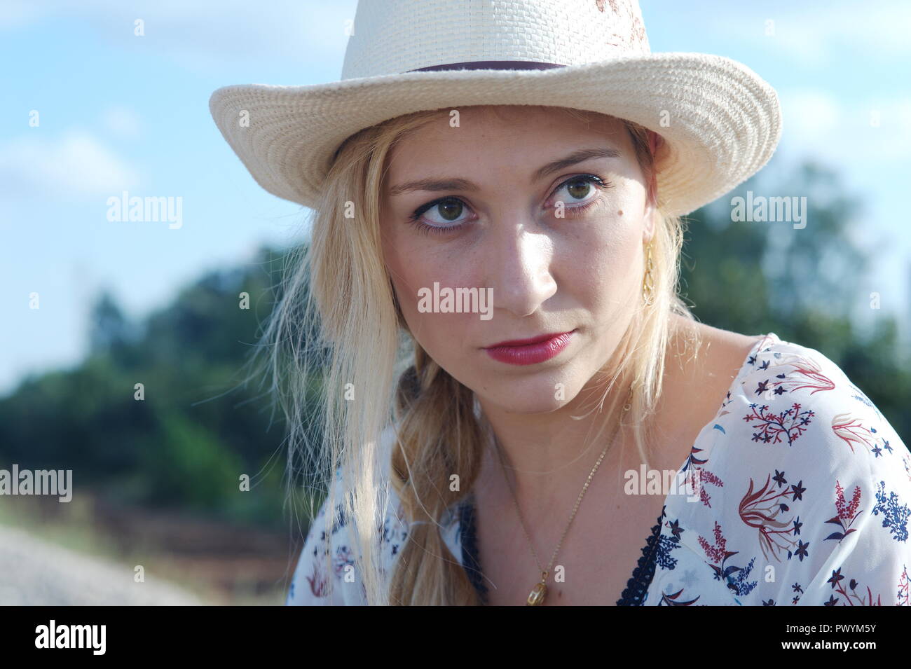 an amazing blonde lady with hat Stock Photo - Alamy