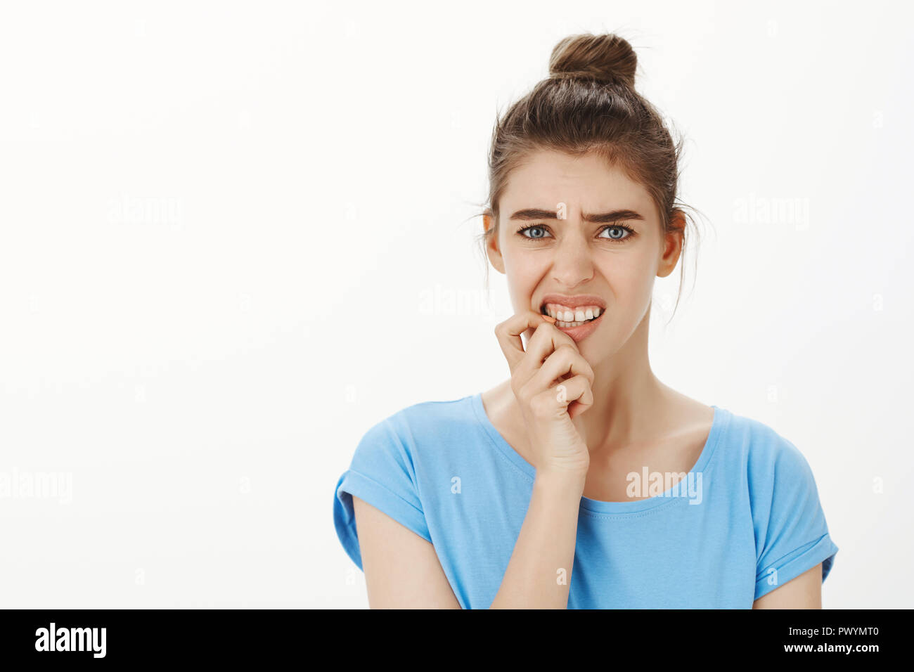 Waist-up shot of intense worried european woman with bun hairstyle ...