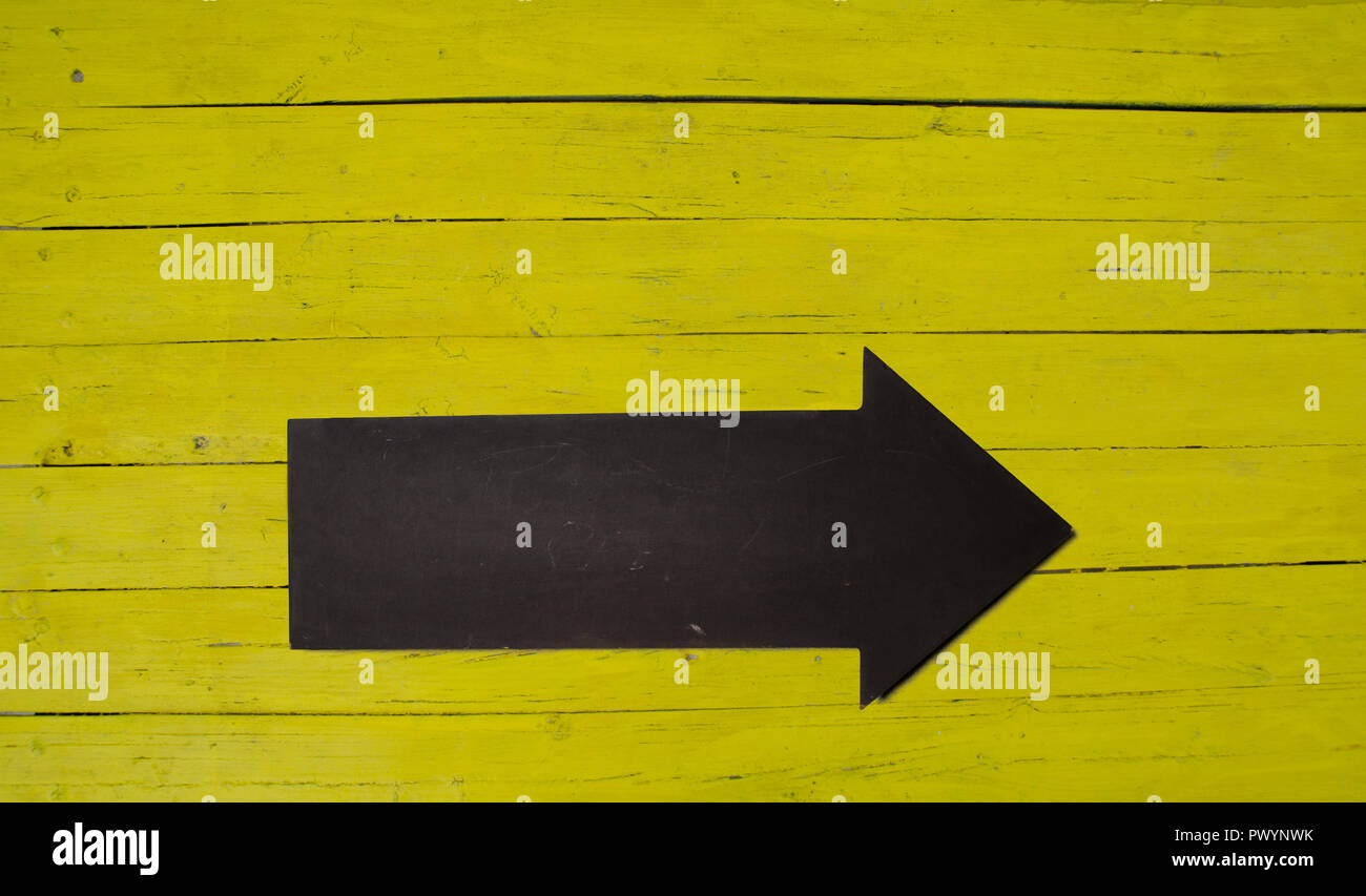 Yellow wood background with blackboard arrow shape on top Stock Photo ...