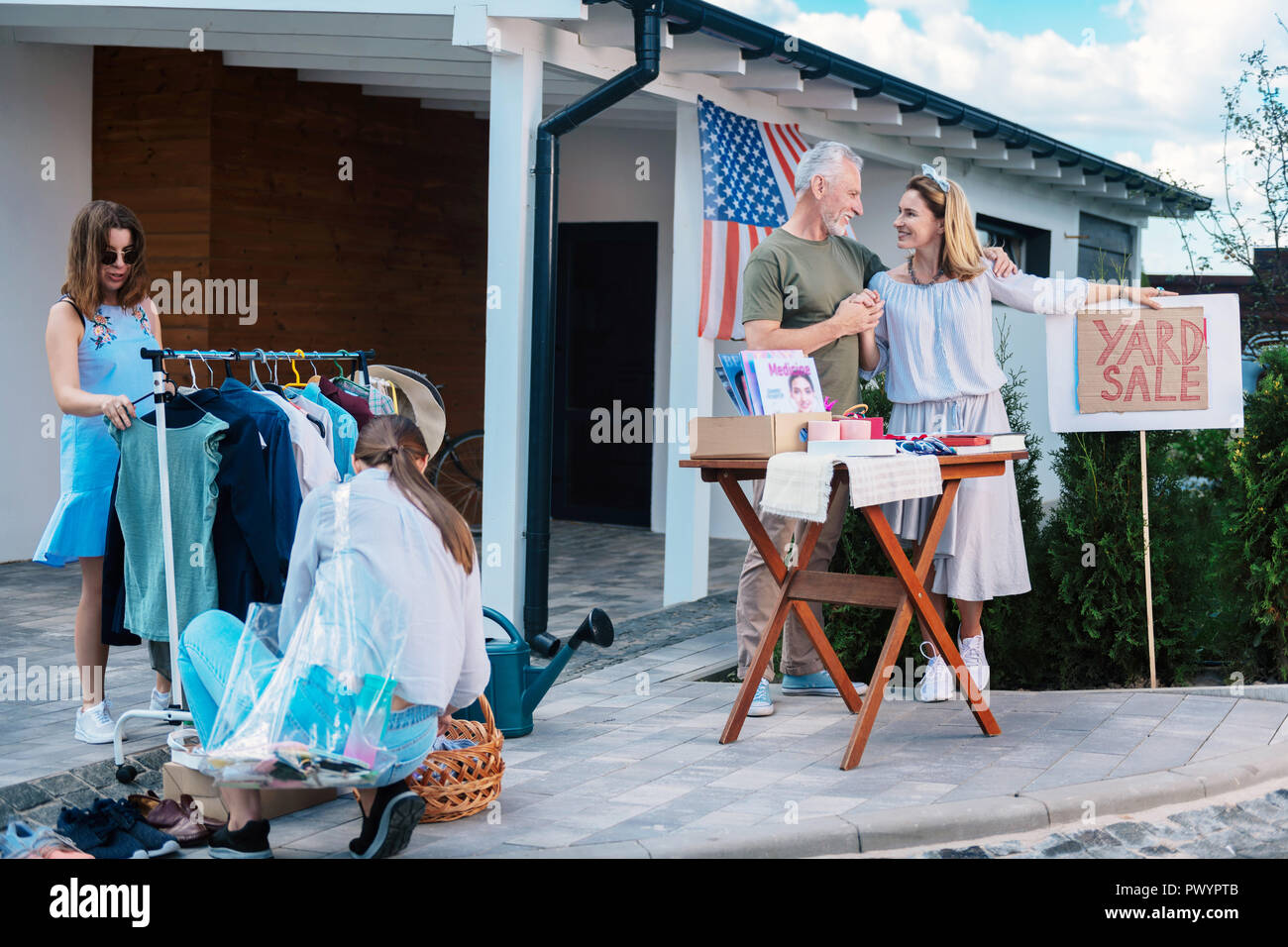 Two young dark-haired women coming to their neighbors while visiting ...