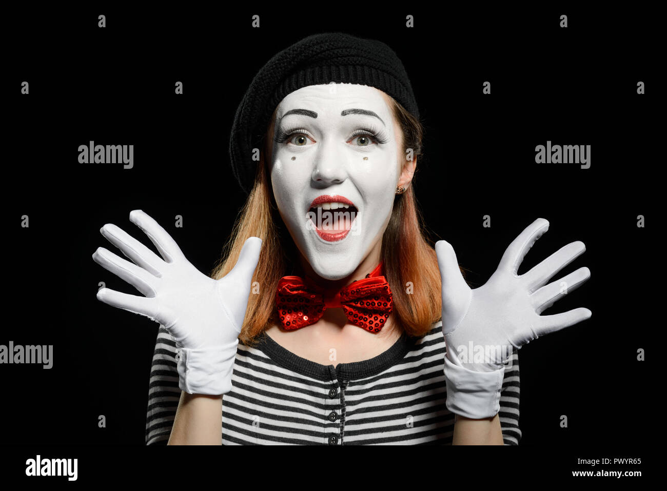Happy female mime on black Stock Photo - Alamy
