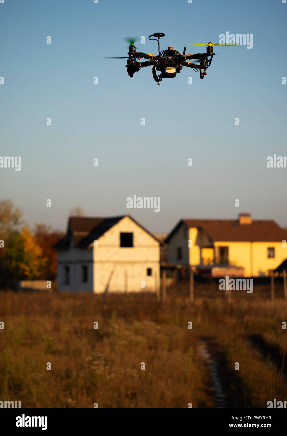 Flying drone above rural buildings Stock Photo - Alamy