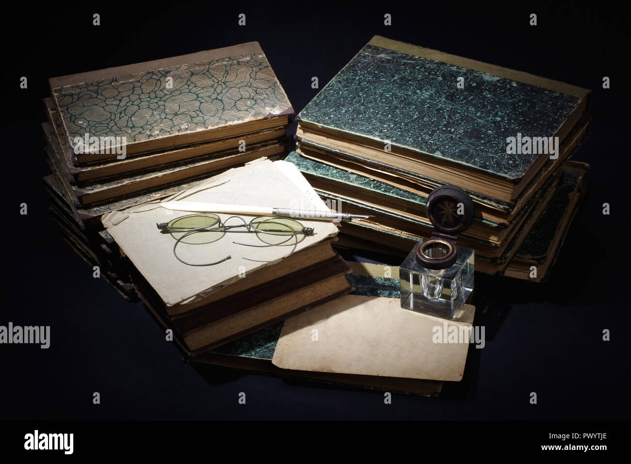 vintage concept - old books, papers, ink pen and inkpot on black ...