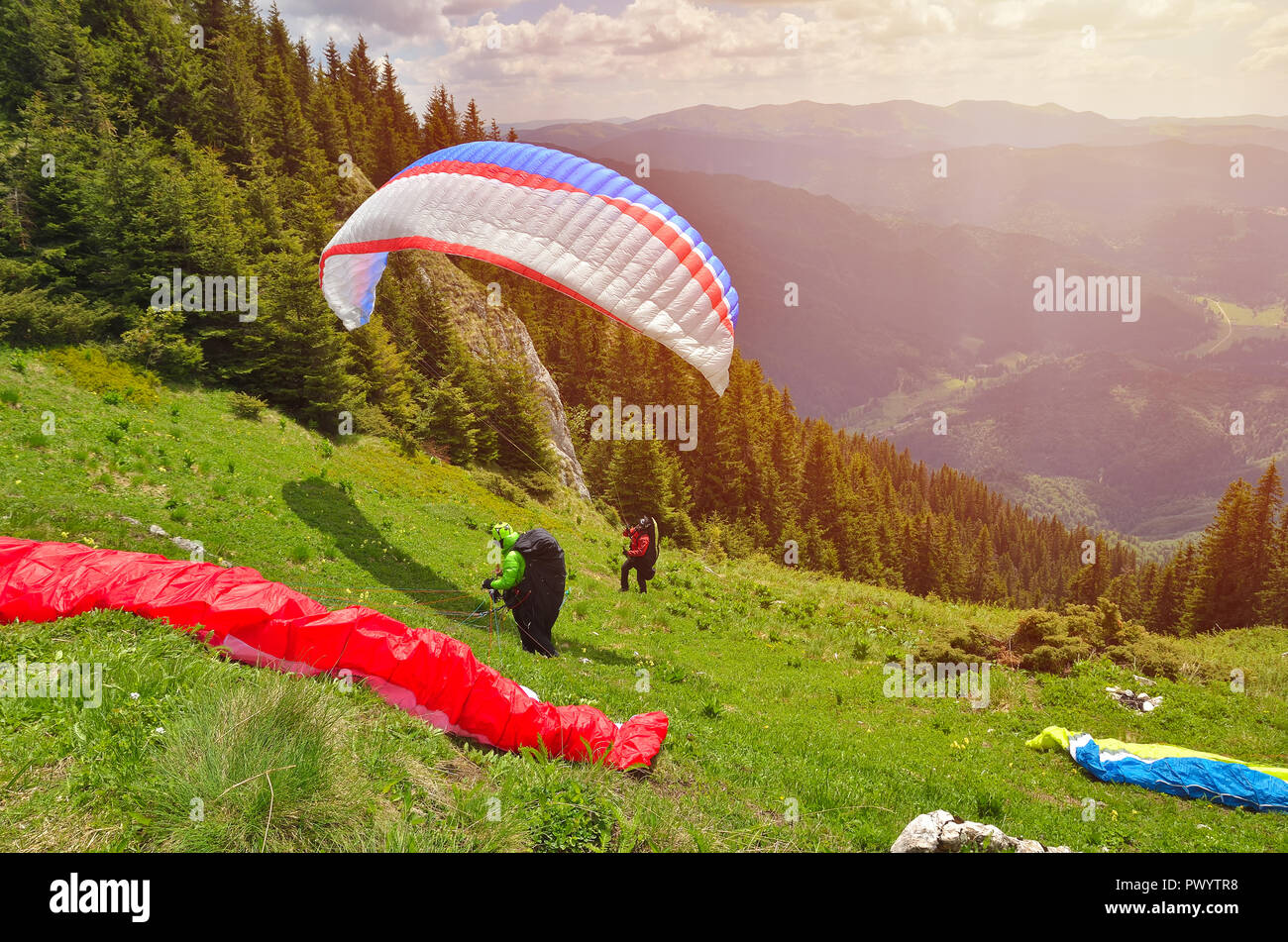 Paraglider taking off in front of spectacular mountain scenery Stock ...