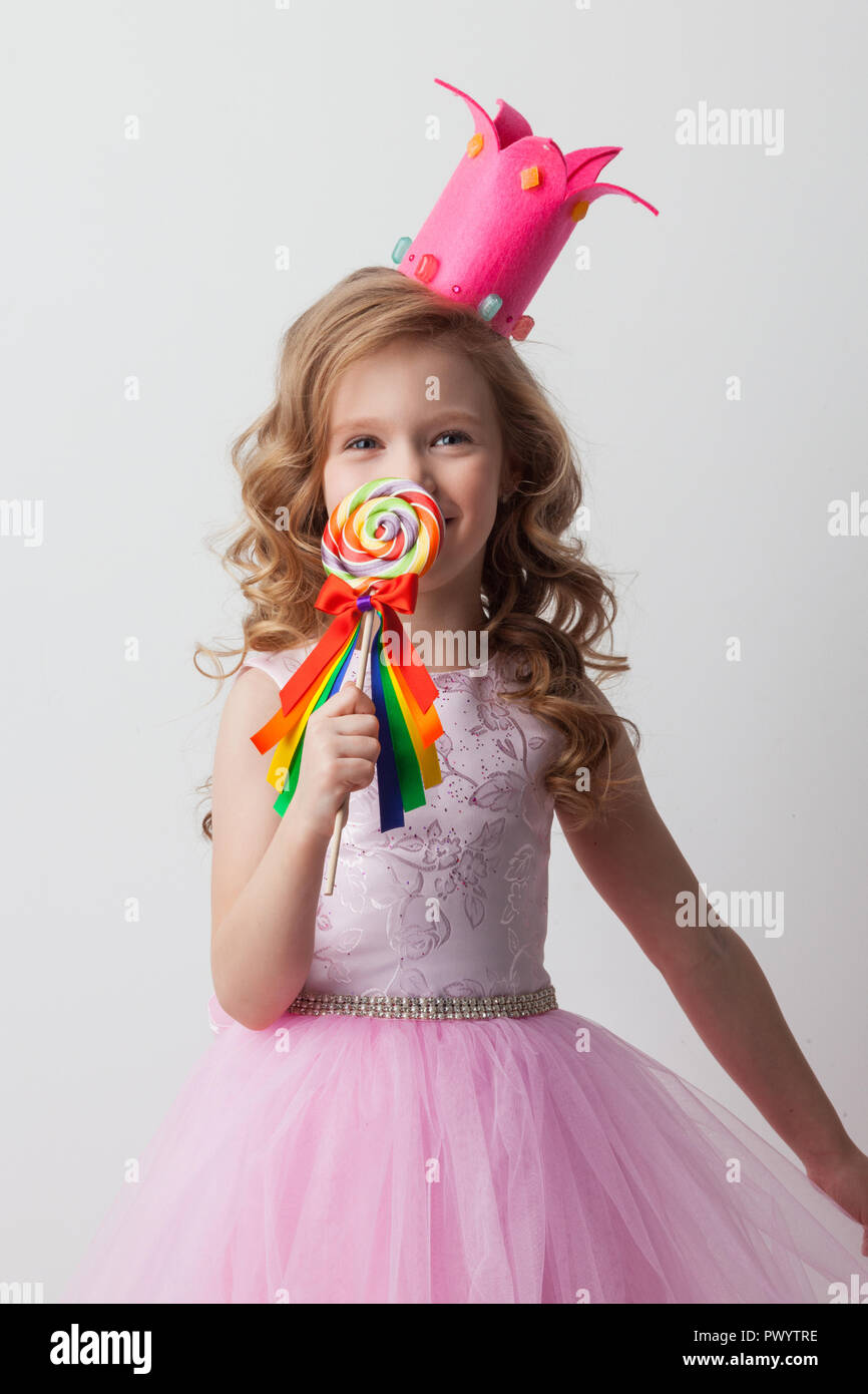 Beautiful little candy princess girl in crown holding big lollipop and ...