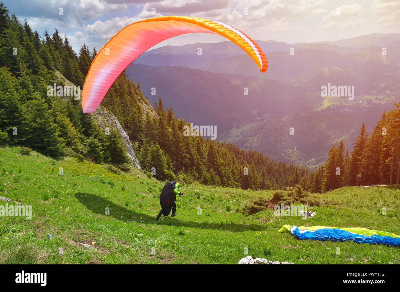 Paraglider taking off in front of spectacular mountain scenery Stock ...