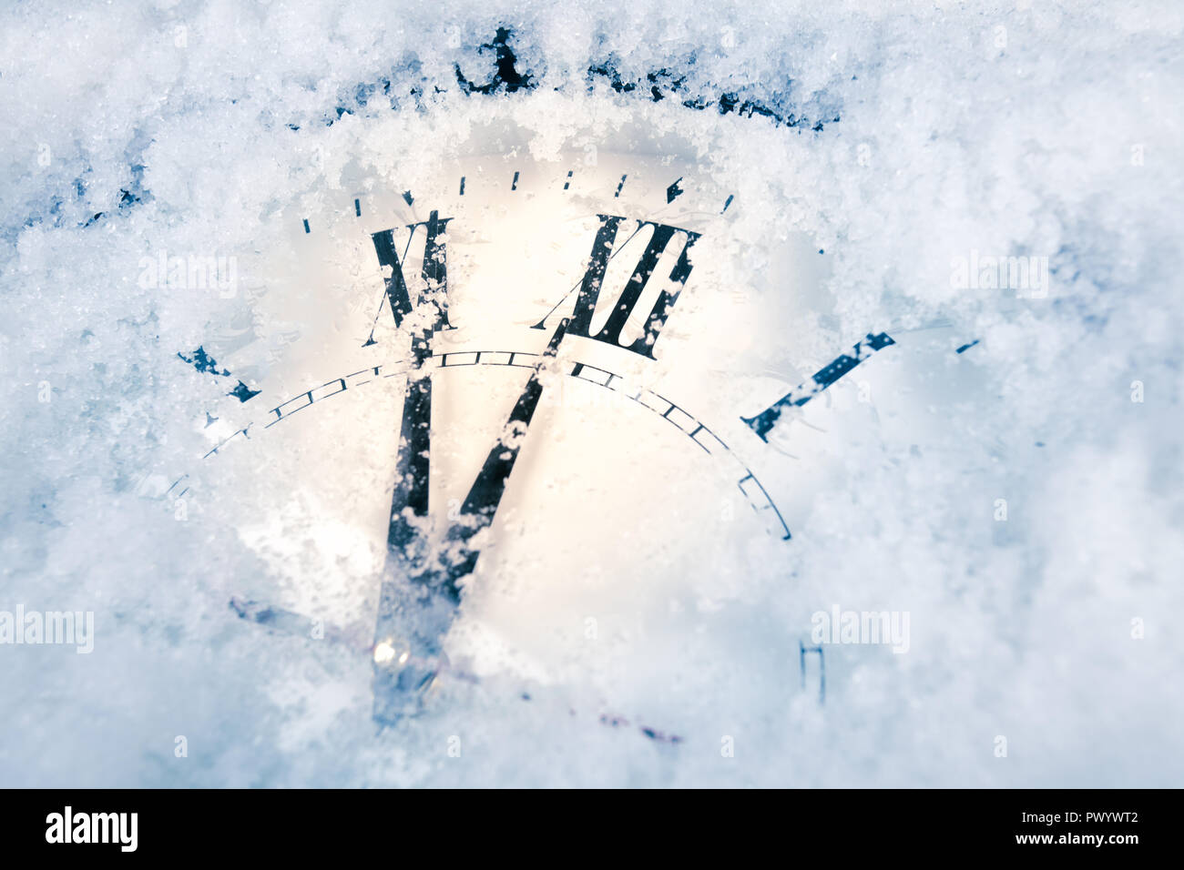 New Year's clock in the snow. christmas card Stock Photo - Alamy