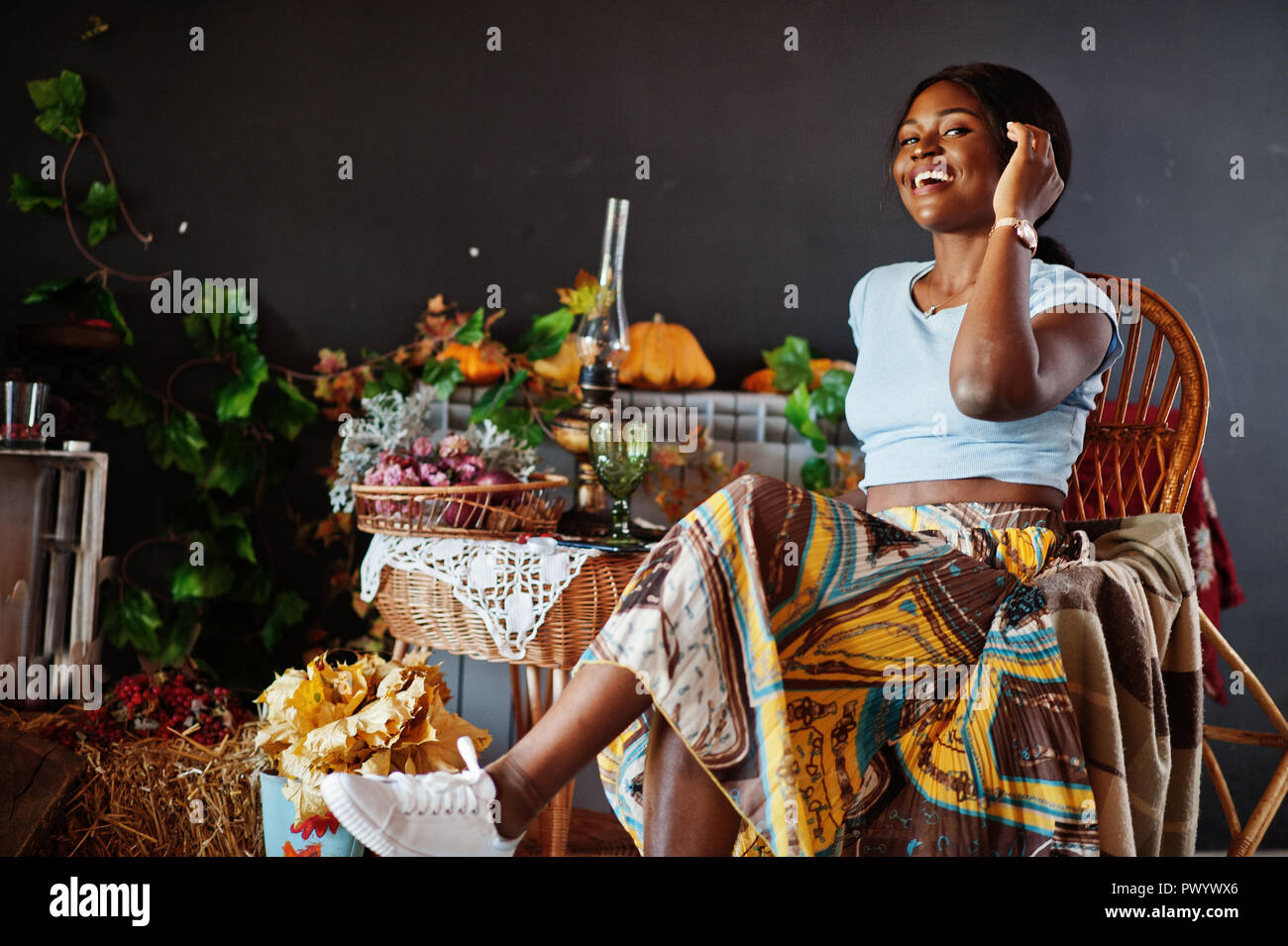 African american girl sitting at rocking chair against autumn mood ...