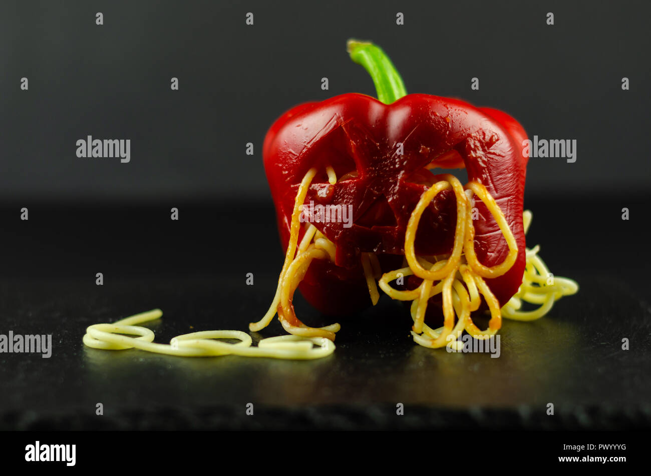 color stuffed peppers with scary cutout faces, halloween party food ...