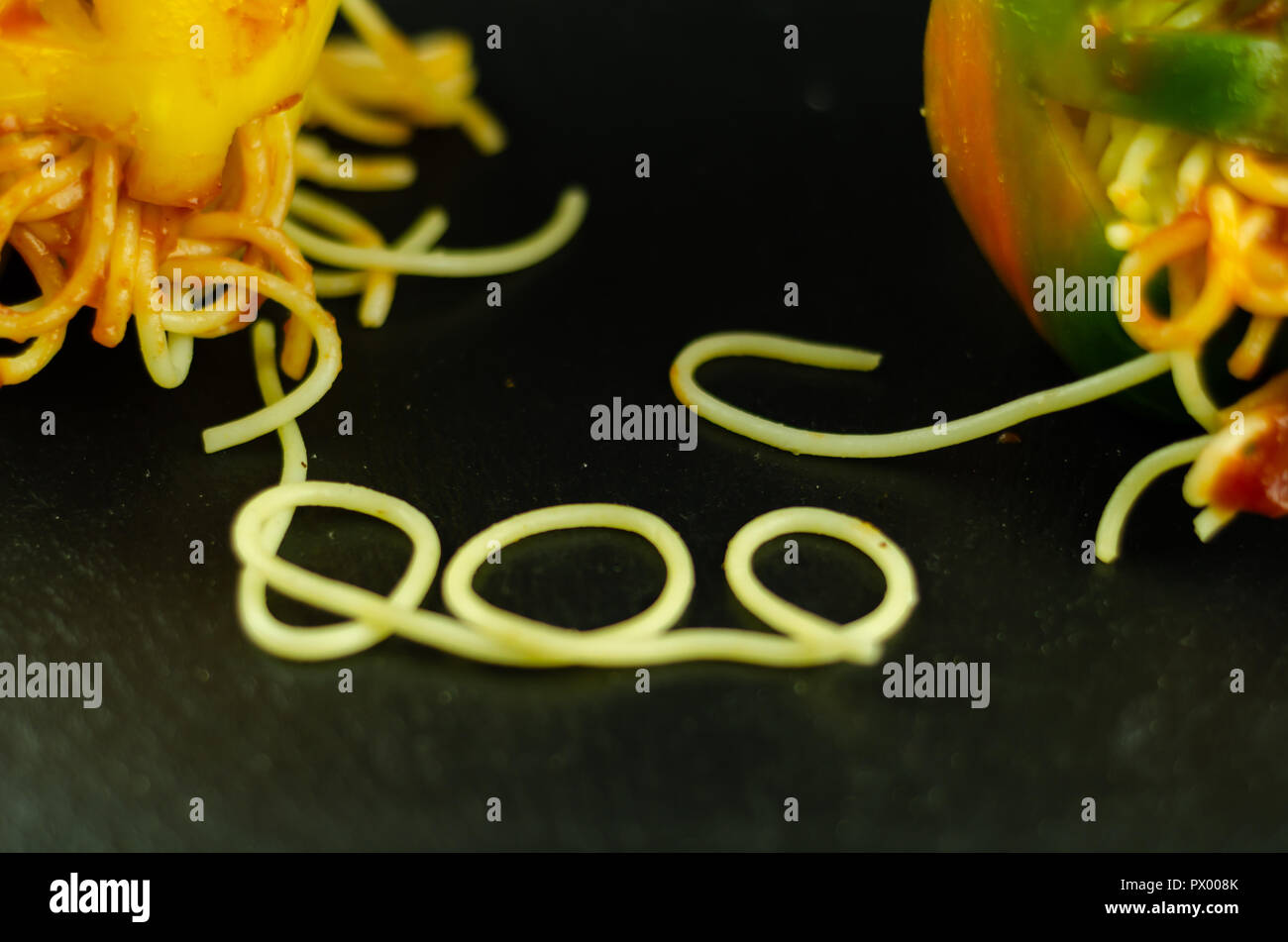 color stuffed peppers with scary cutout faces, halloween party food ...