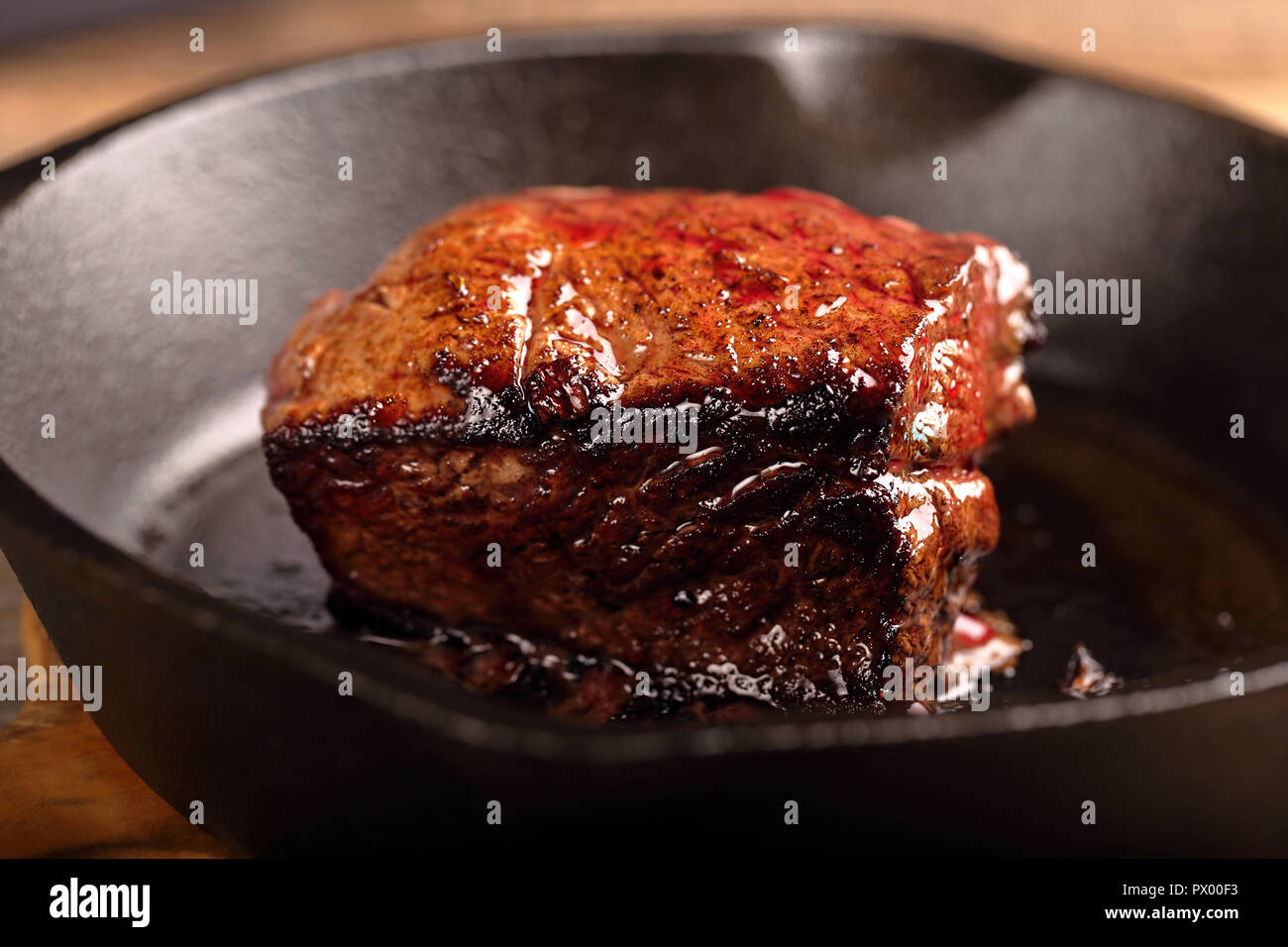 Beef steak on cast iron skillet Stock Photo - Alamy