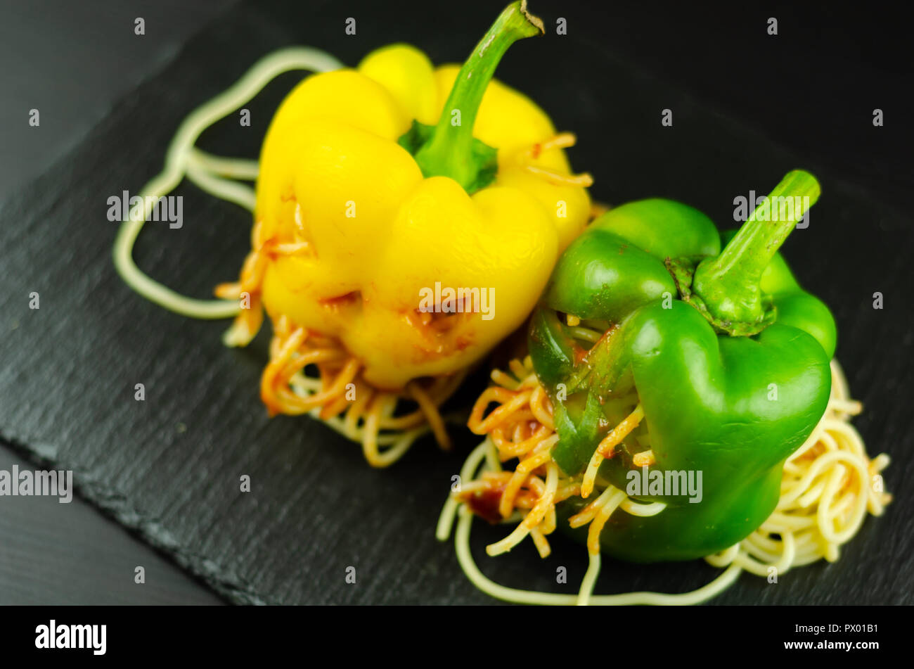 color stuffed peppers with scary cutout faces, halloween party food ...