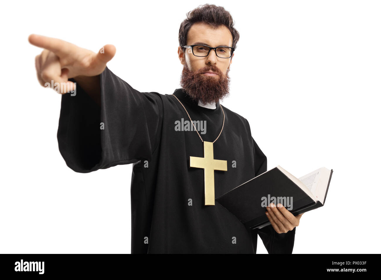 Priest holding a bible and pointing isolated on white background Stock ...