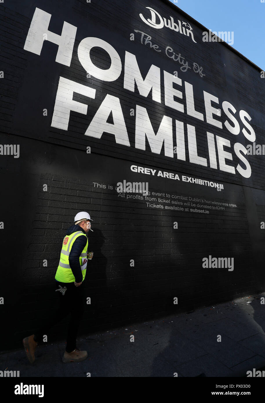 A construction worker walks past a new mural in Dublin's city centre by ...
