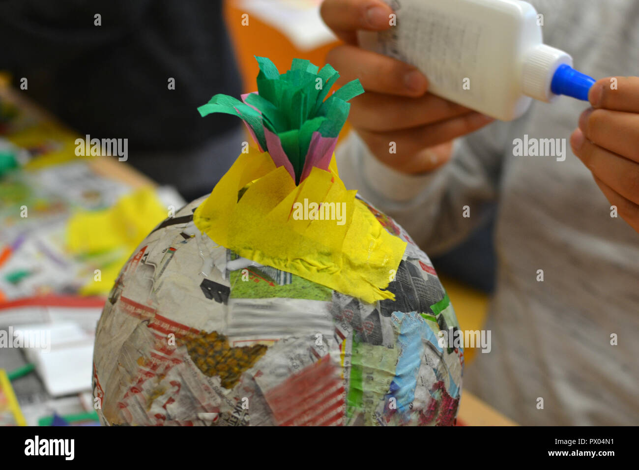 Children hands are making a pinata with colorful paper and glue Stock ...