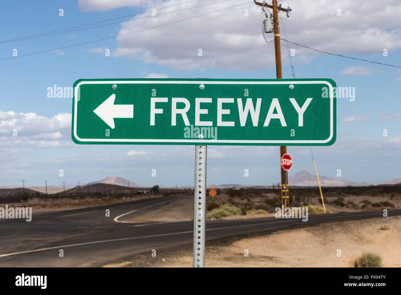 Weathered Mojave desert freeway arrow sign between Barstow and Baker in ...