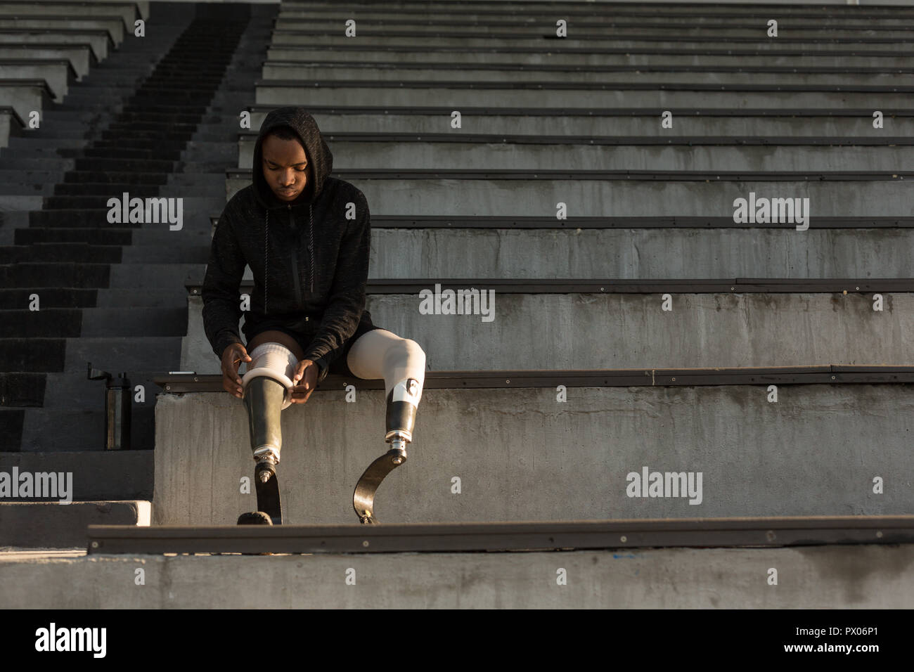 Disabled athletic wearing prosthetic legs at sports venue Stock Photo ...