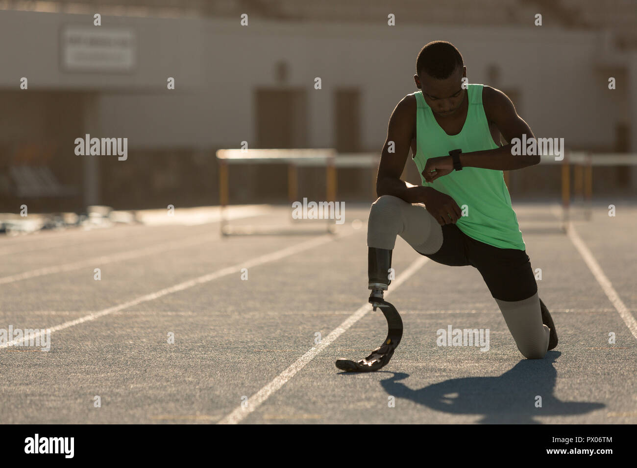 Disabled athletic checking time on a running track Stock Photo - Alamy