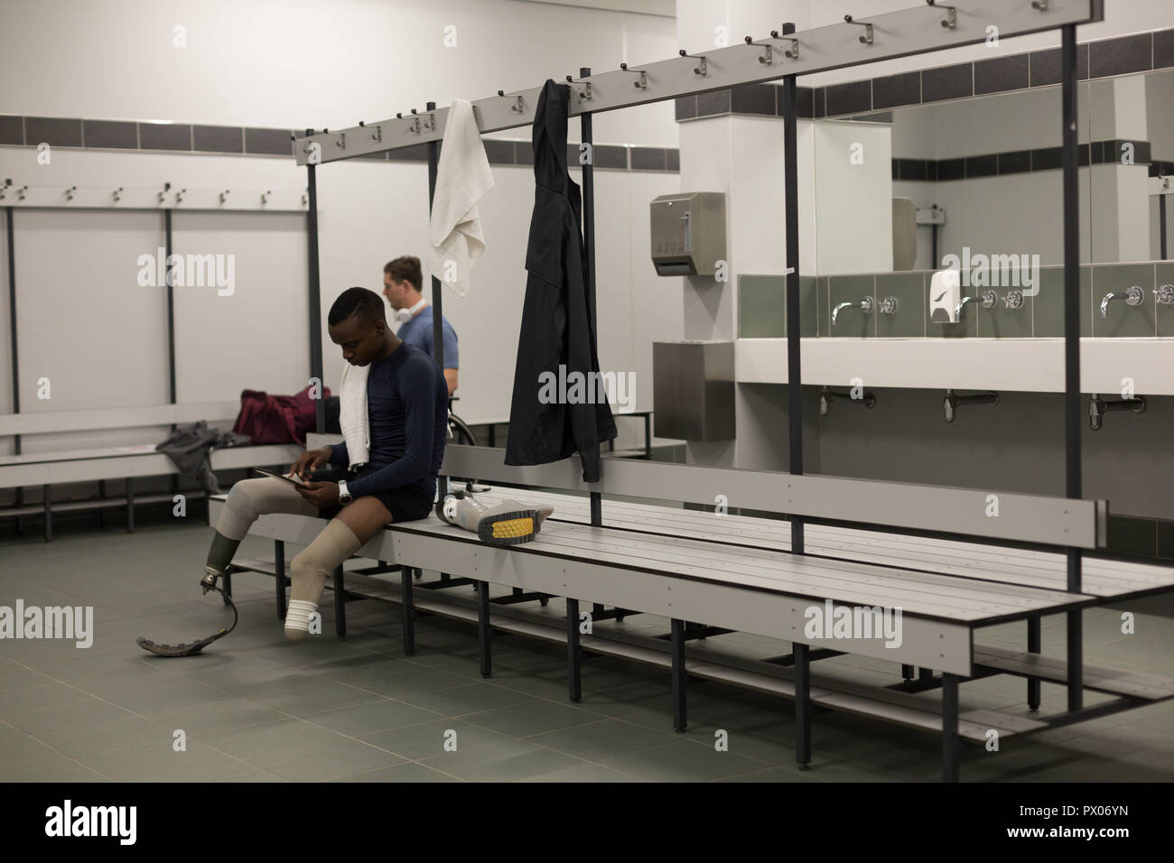 Two disabled athletics relaxing in changing room Stock Photo - Alamy