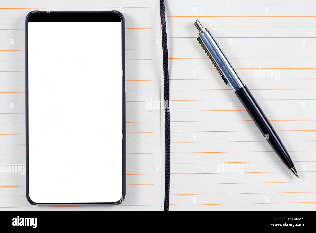 Notepad with elegant pen and bezel less smartphone with blank screen ...
