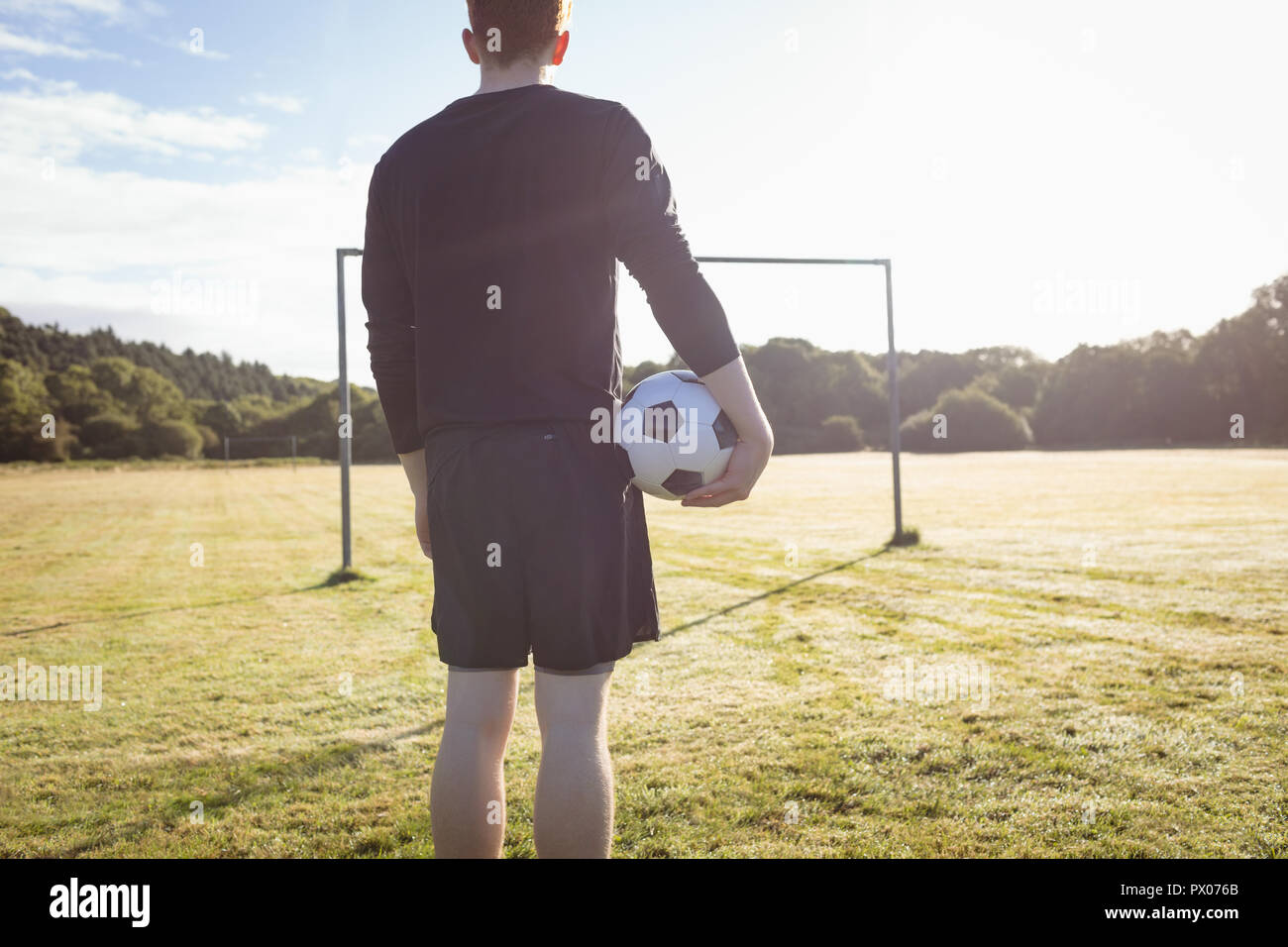 Football player standing ball hi-res stock photography and images - Alamy