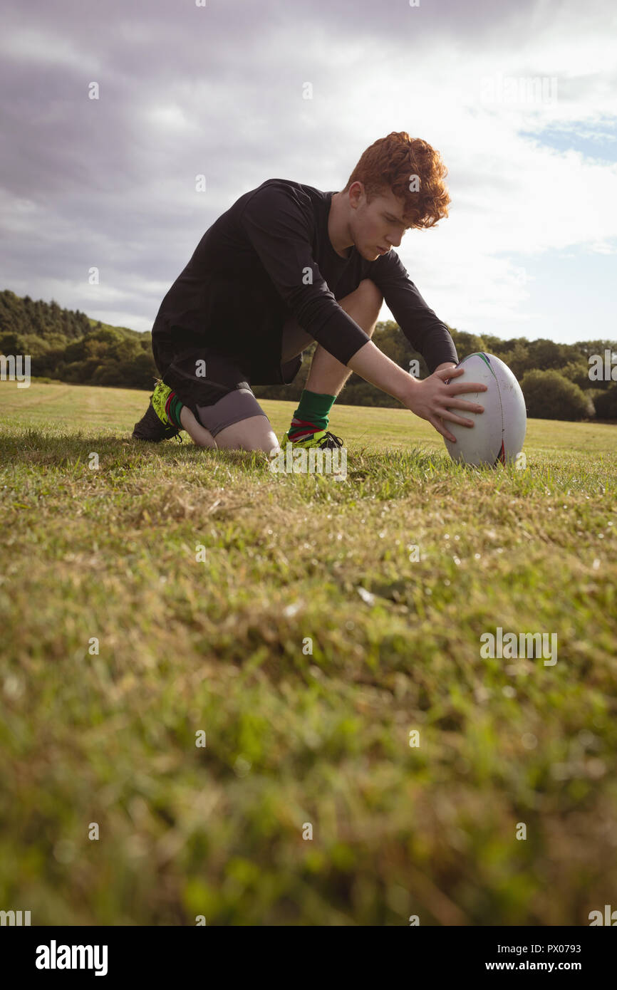Rugby player placing rugby ball in the field Stock Photo - Alamy