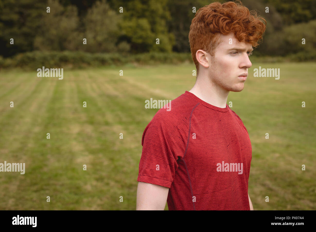 Football player standing in the field Stock Photo - Alamy