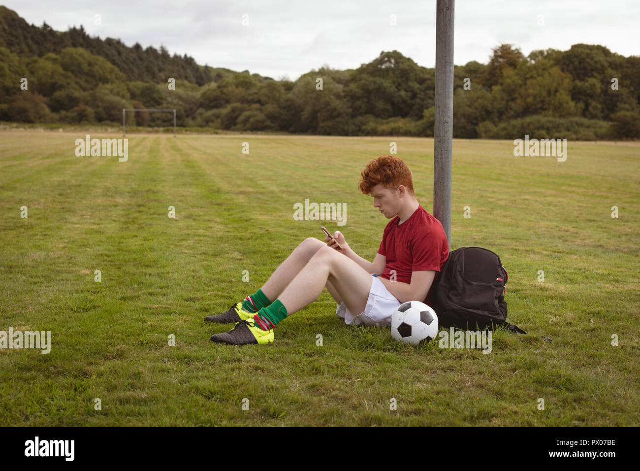 Football player using mobile phone in the field Stock Photo - Alamy