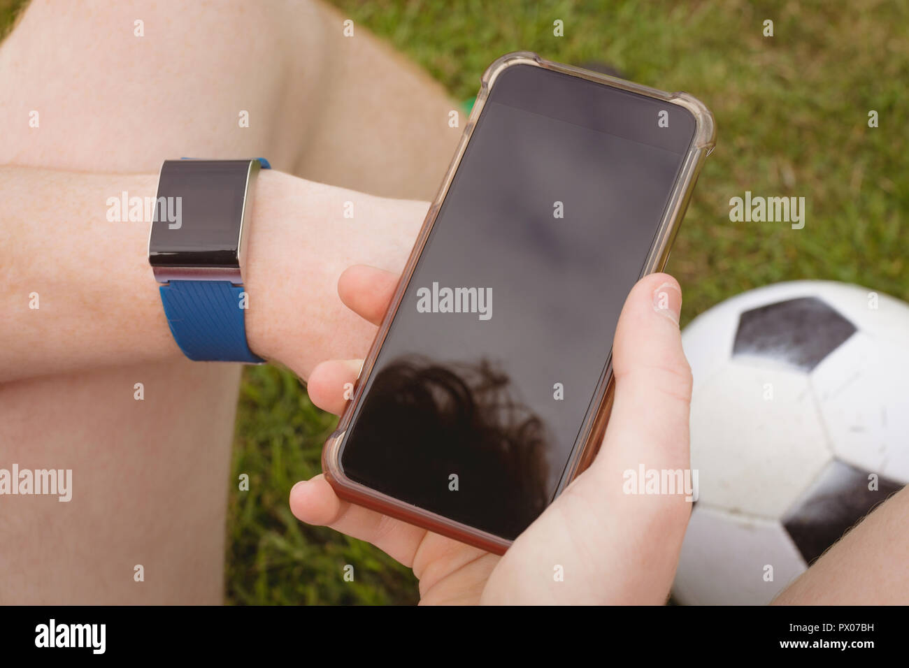 Football player using mobile phone in the field Stock Photo - Alamy