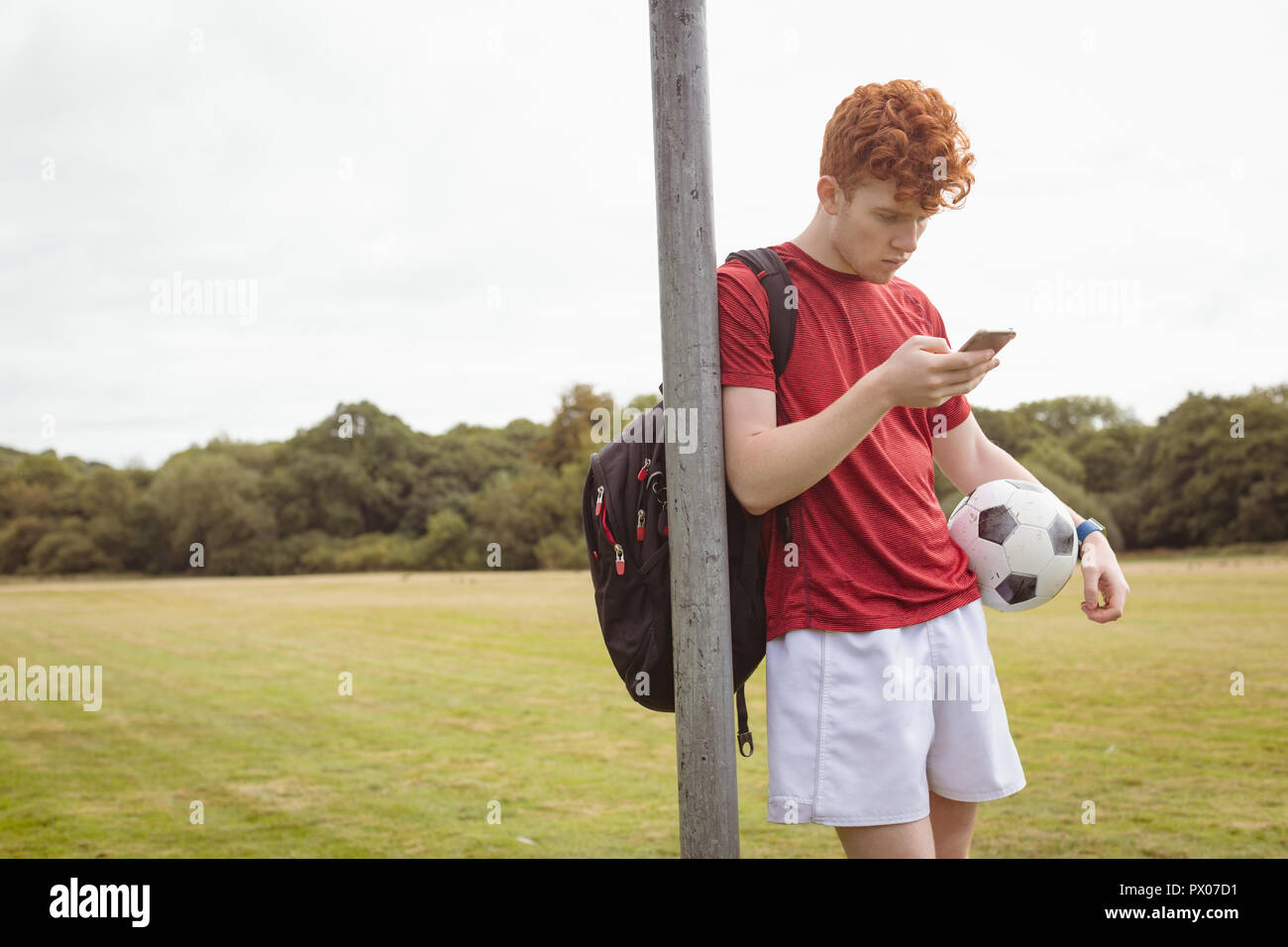 Football player using mobile phone in the field Stock Photo - Alamy