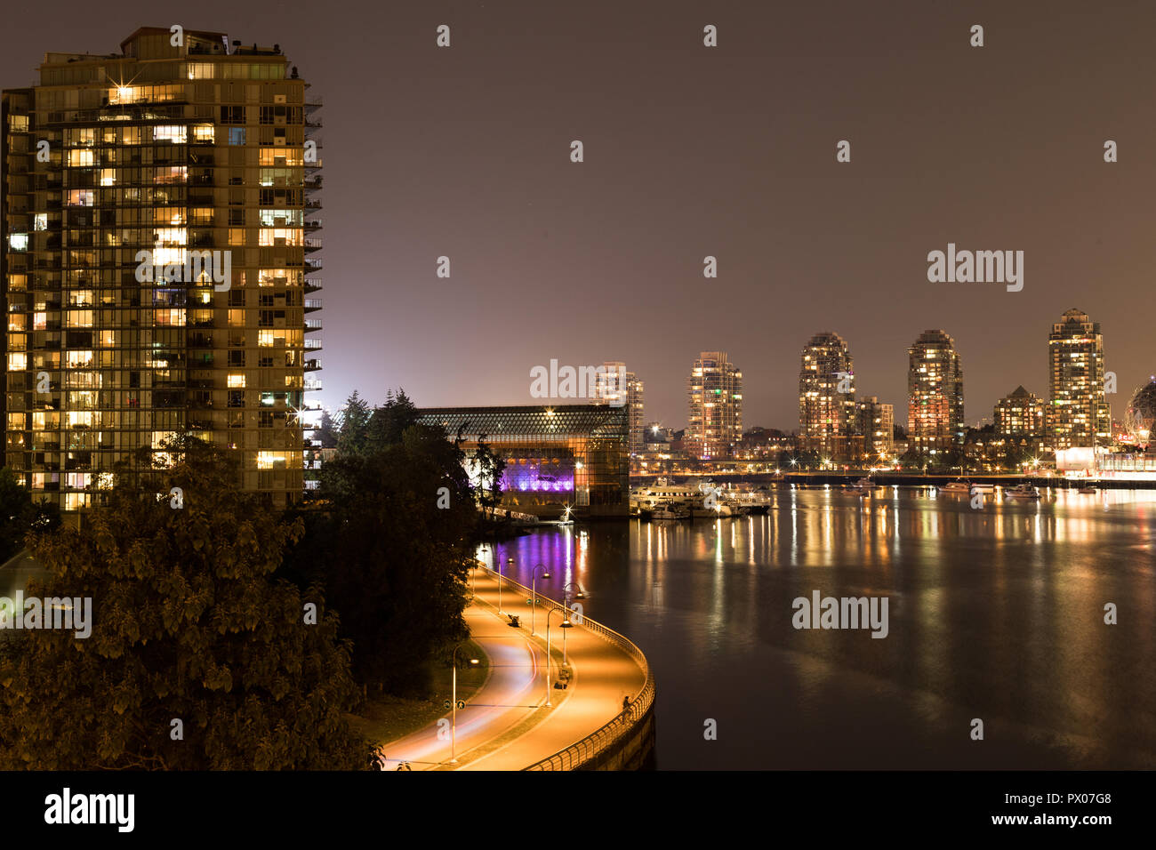 Downtown with light trail and river Stock Photo - Alamy