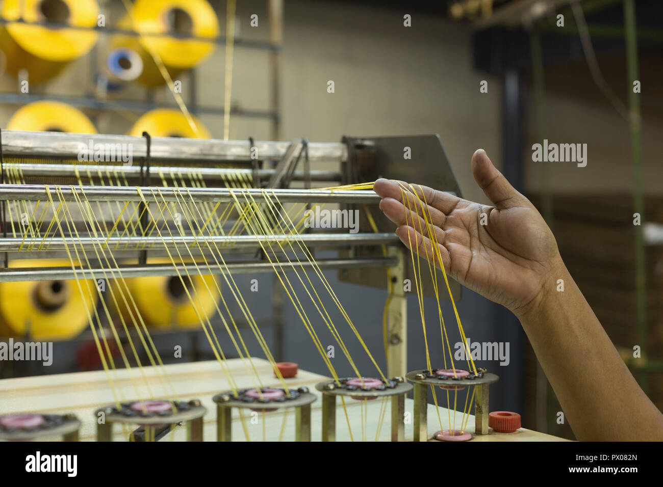 Worker checking thread in machine at rope making industry Stock Photo ...
