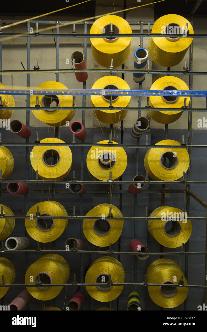 Thread roll arranged in rack Stock Photo - Alamy