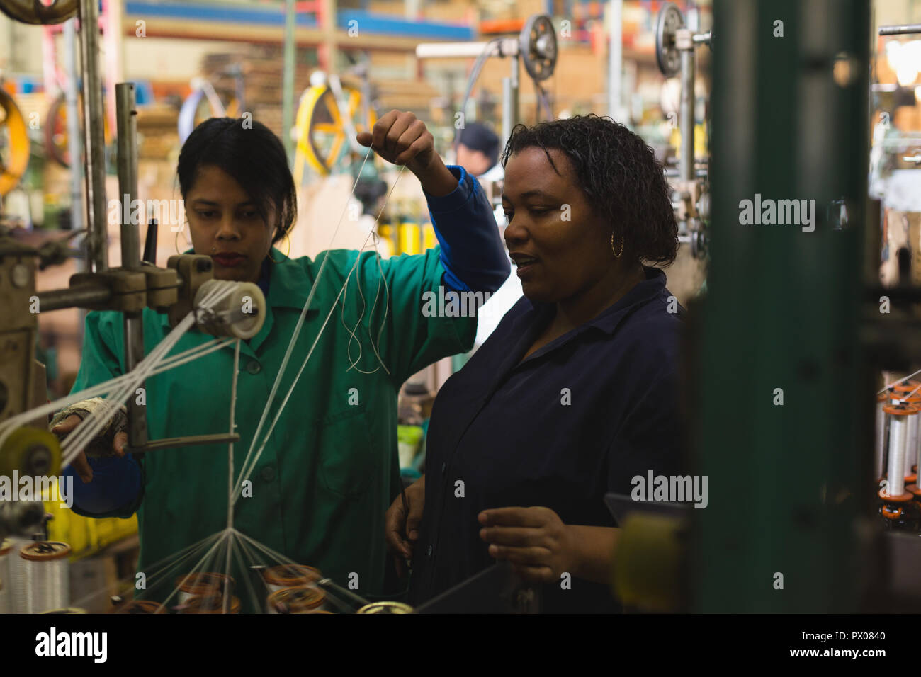 Coworker working in rope making industry Stock Photo - Alamy