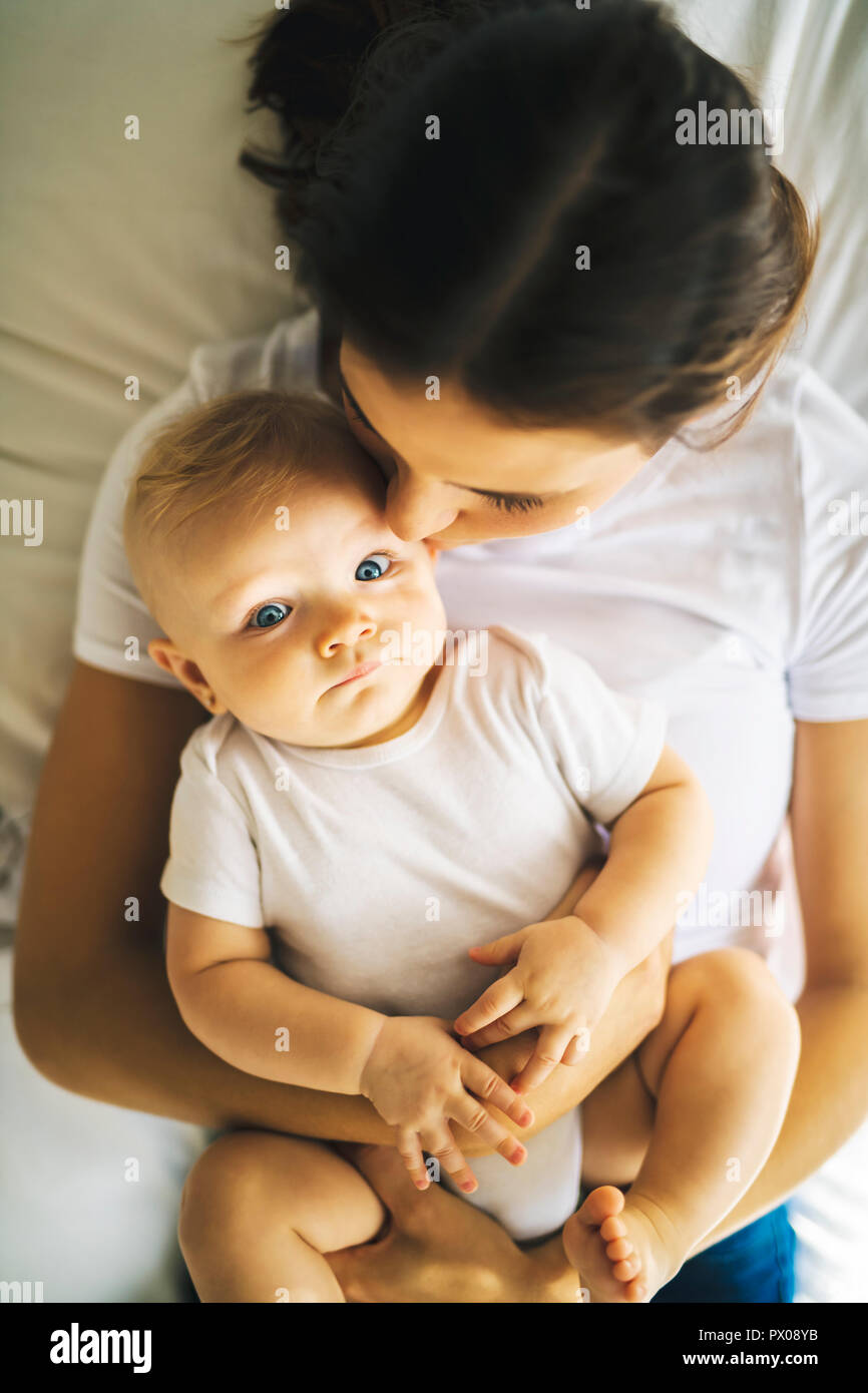 mother with baby on bed having good time Stock Photo - Alamy