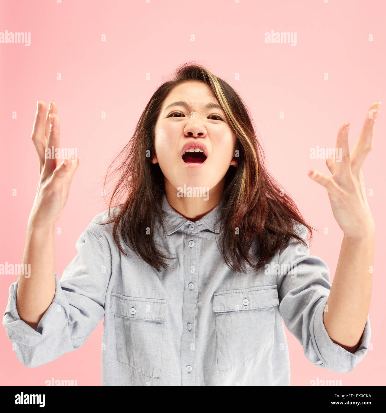 Screaming, hate, rage. Crying emotional angry woman screaming on pink ...