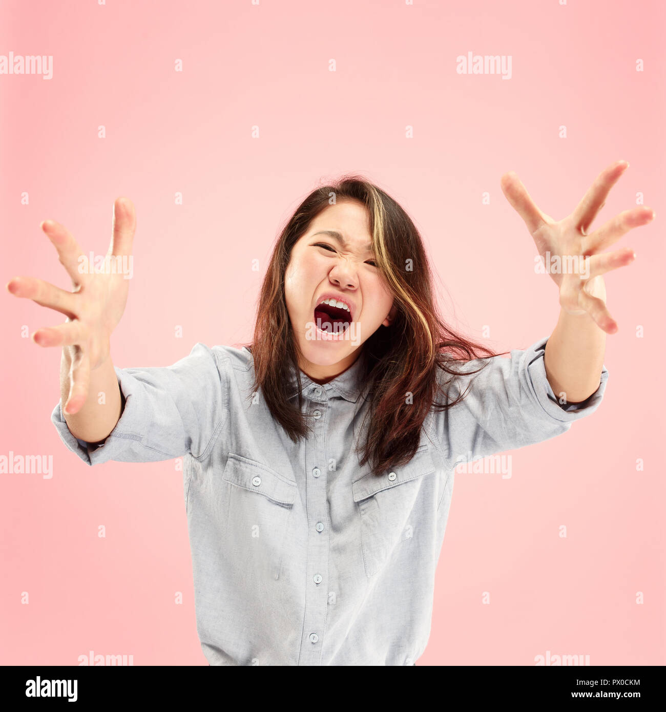 Screaming, hate, rage. Crying emotional angry woman screaming on pink ...