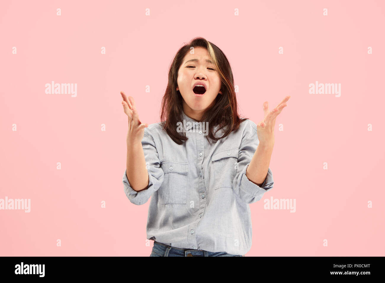Screaming, hate, rage. Crying emotional angry woman screaming on pink ...