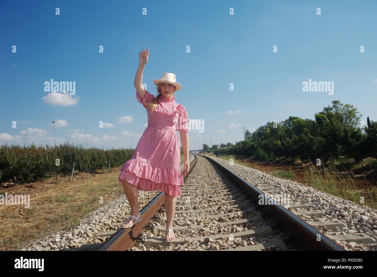 an amazing blonde woman ask for hitchhiking from loco, locomotive Stock ...