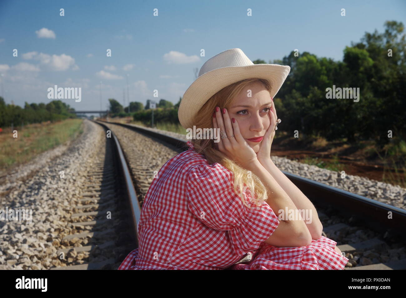 an amazing blonde woman ask for hitchhiking from loco, locomotive Stock ...