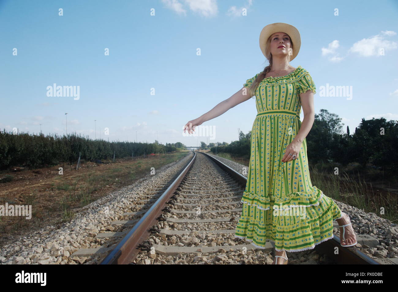 an amazing blonde woman ask for hitchhiking from loco, locomotive Stock ...