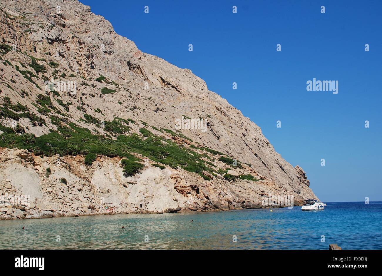 People swim in the Cala de Boquer on the Spanish island of Majorca on ...