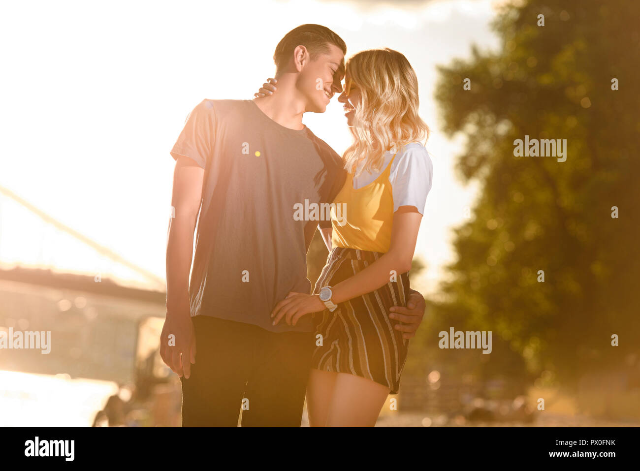 Kiss beach couple hugging hi-res stock photography and images - Alamy