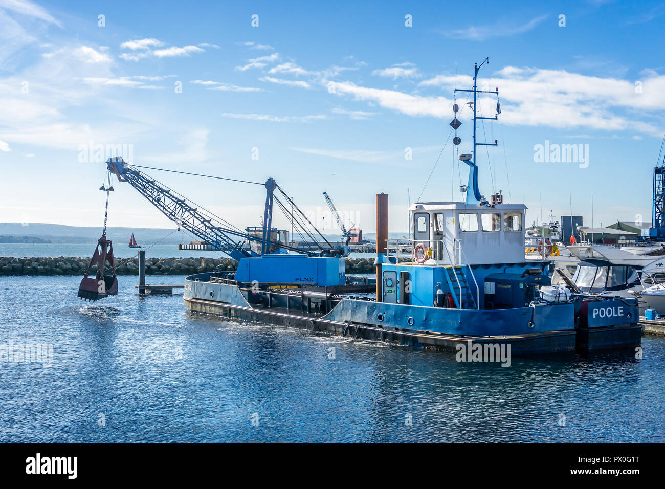 Grab Dredger C H Horn at work dredging Poole Harbour marina in Dorset ...
