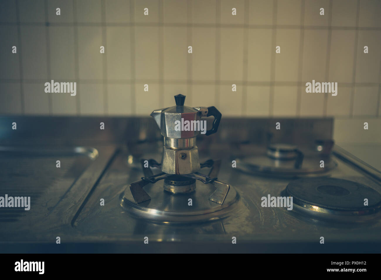 A moka pot on a stove in a kitchen Stock Photo - Alamy