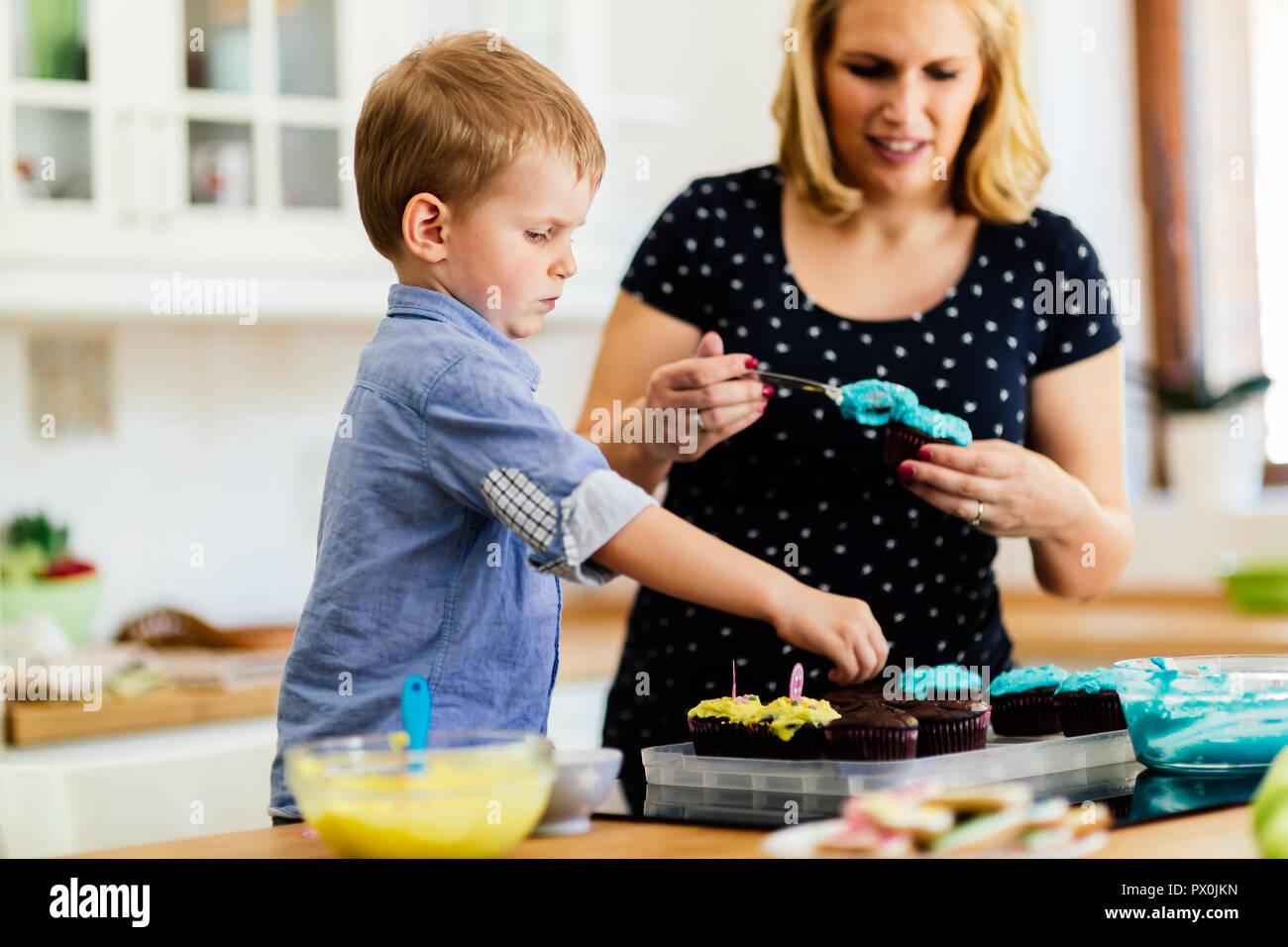 Child helping mother bake cookies Stock Photo - Alamy