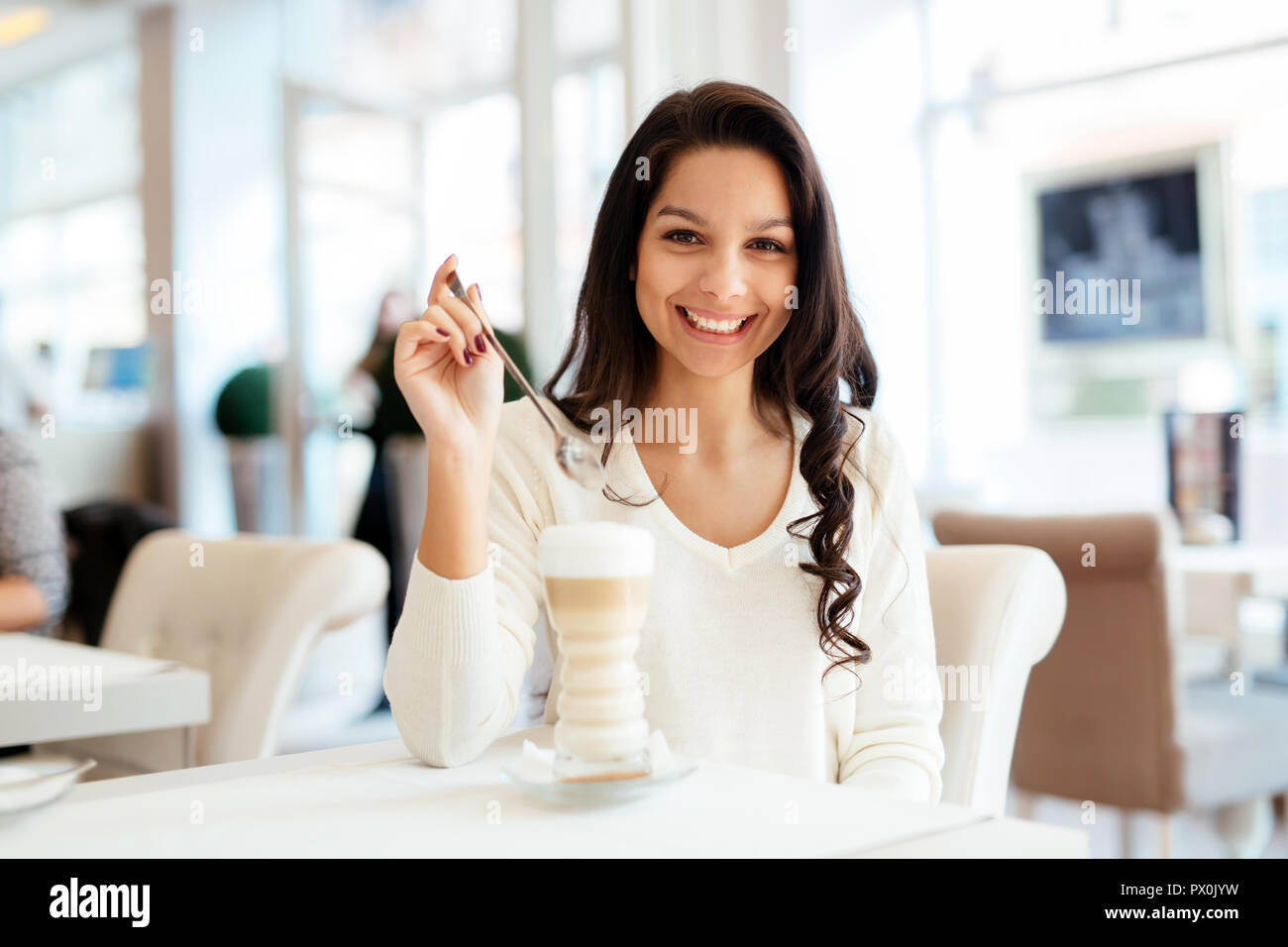 Glamorous lady drinking coffee in a beautiful cafe Stock Photo - Alamy
