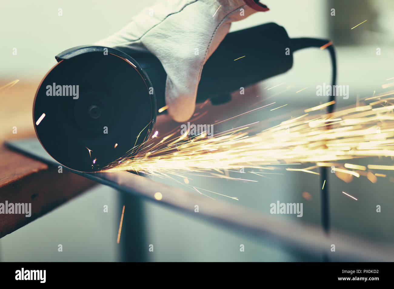 Worker grinding a metal plate Stock Photo - Alamy